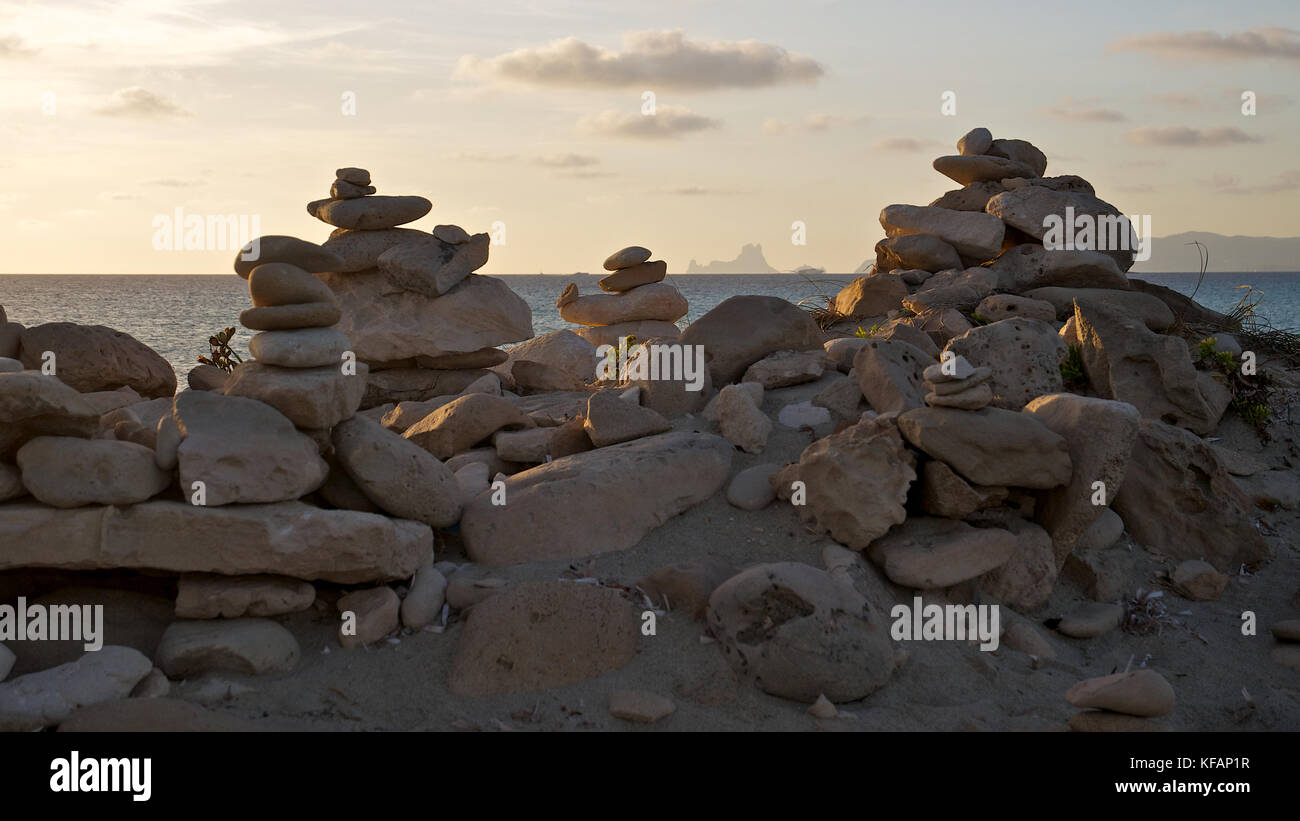 Sunset with stone piles at Ses Illetes beach with Es Vedrá and Ibiza ...