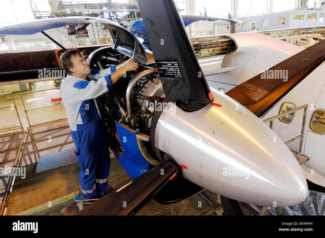 man working on a PW124B turboprop engine on an Aero Airlines ATR 72-200 ...