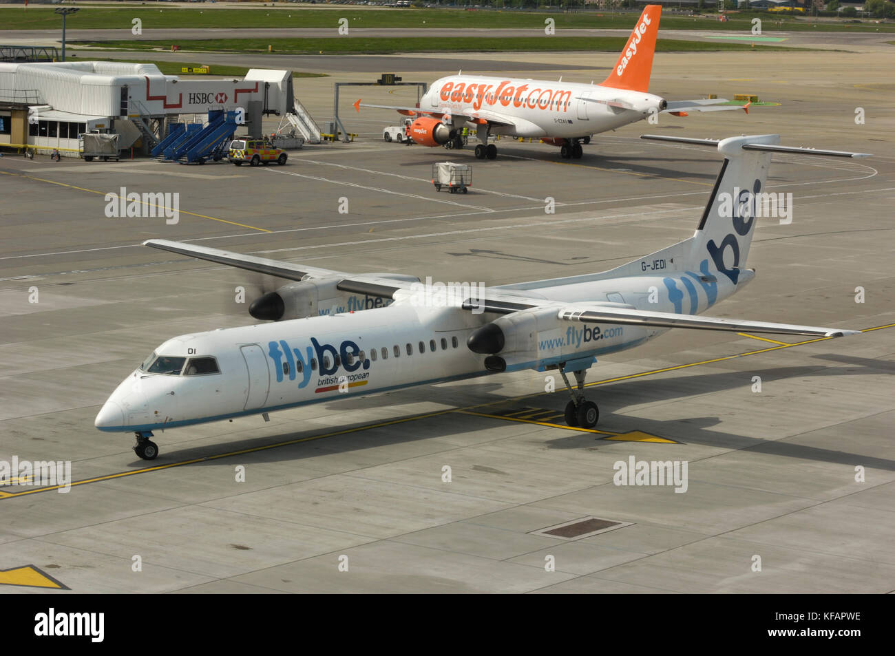 a Flybe Bombardier DHC-8 Dash 8-400 Q400 taxiing with an easyJet Airbus ...