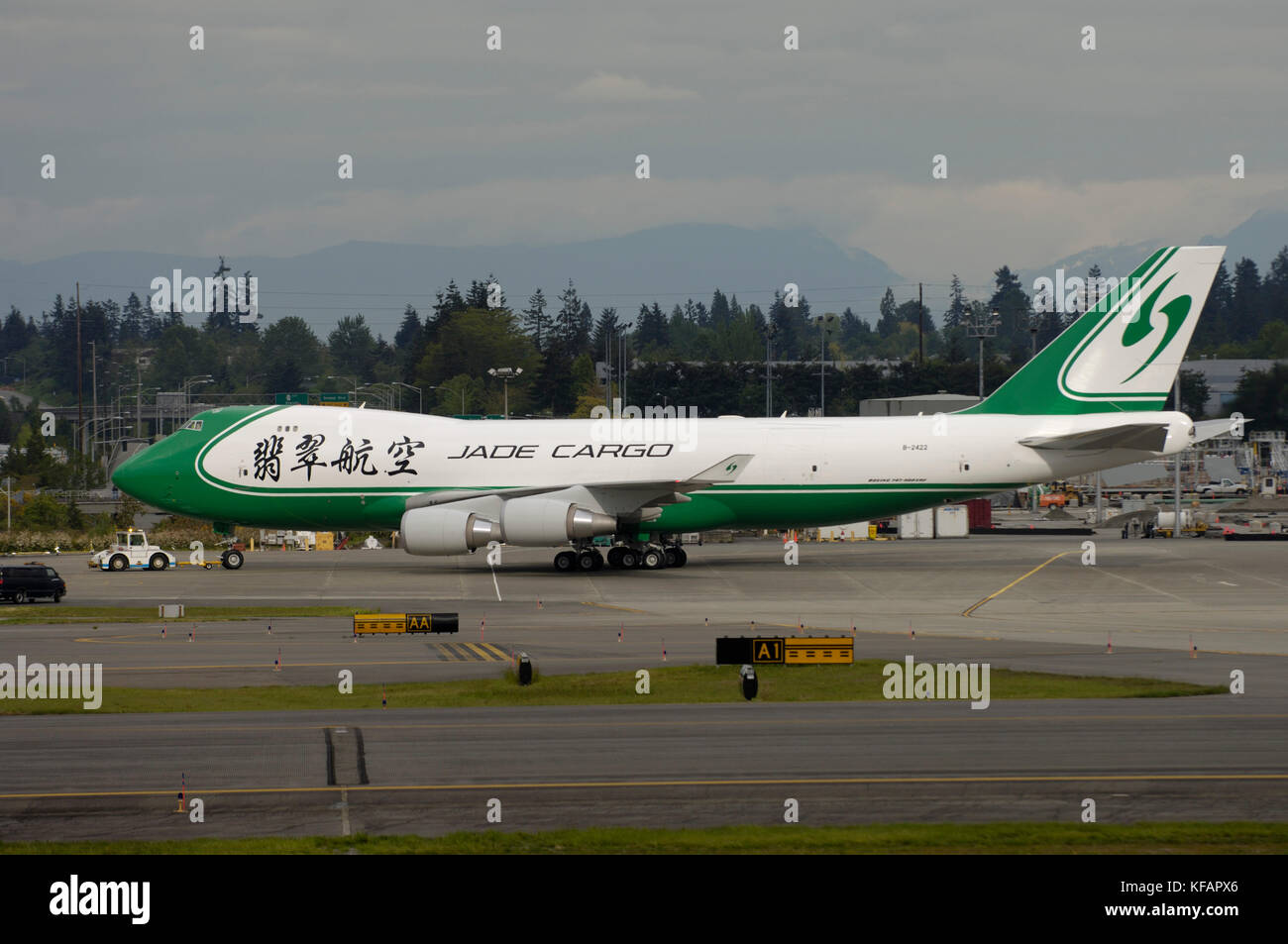 a Jade Cargo International Boeing 747-400 freighter being towed by a ...