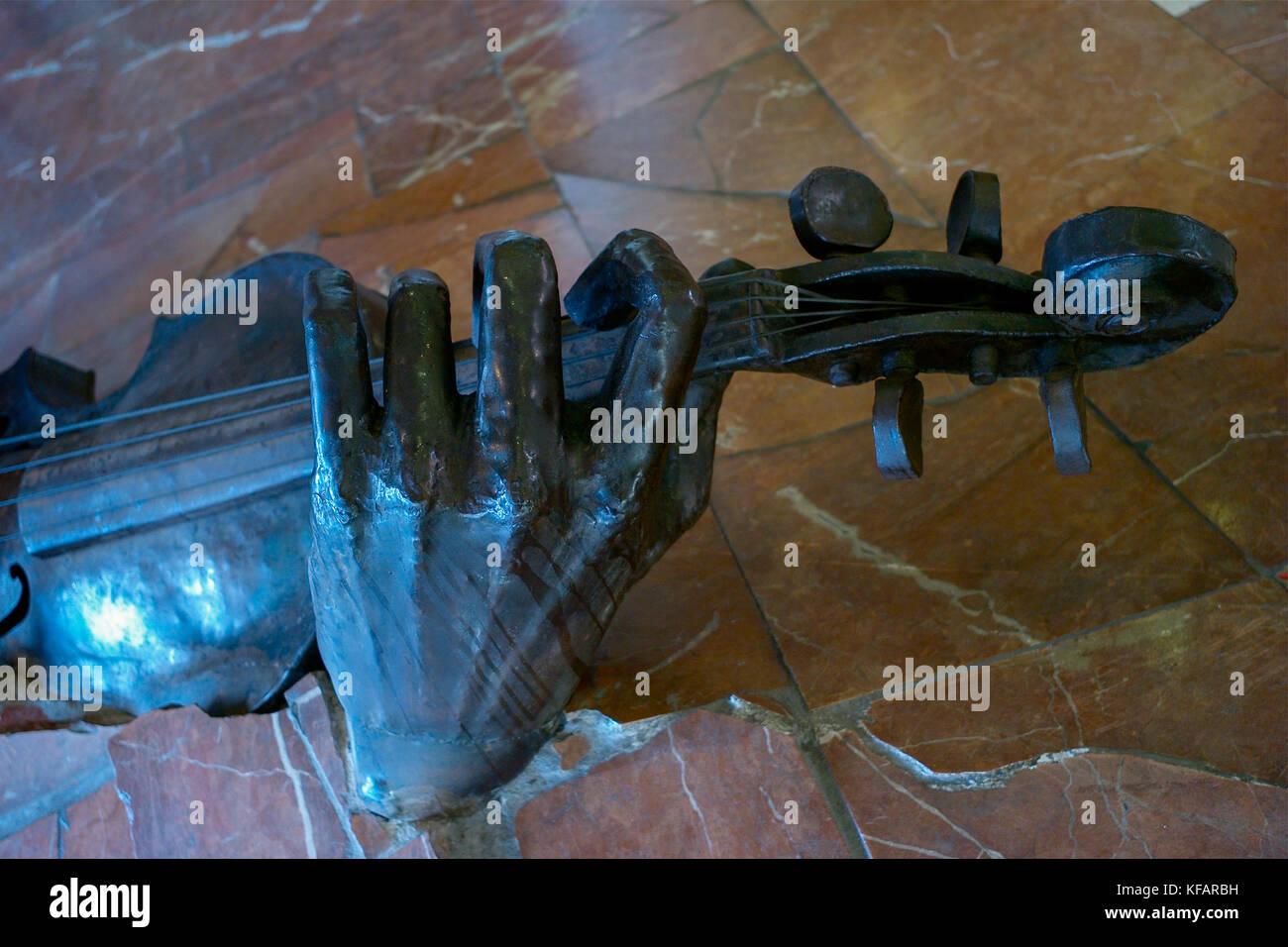 Brass sculpture of a stylized Violin player bursting off the ground at ...