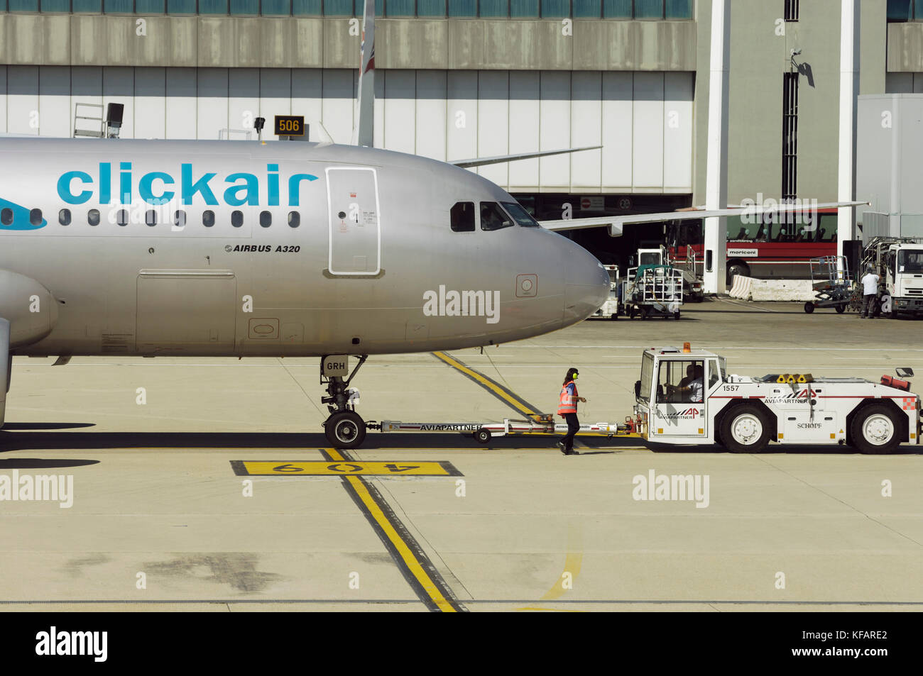 forward fuselage of a clickair Airbus A320-200, a tug with a towbar, an ...