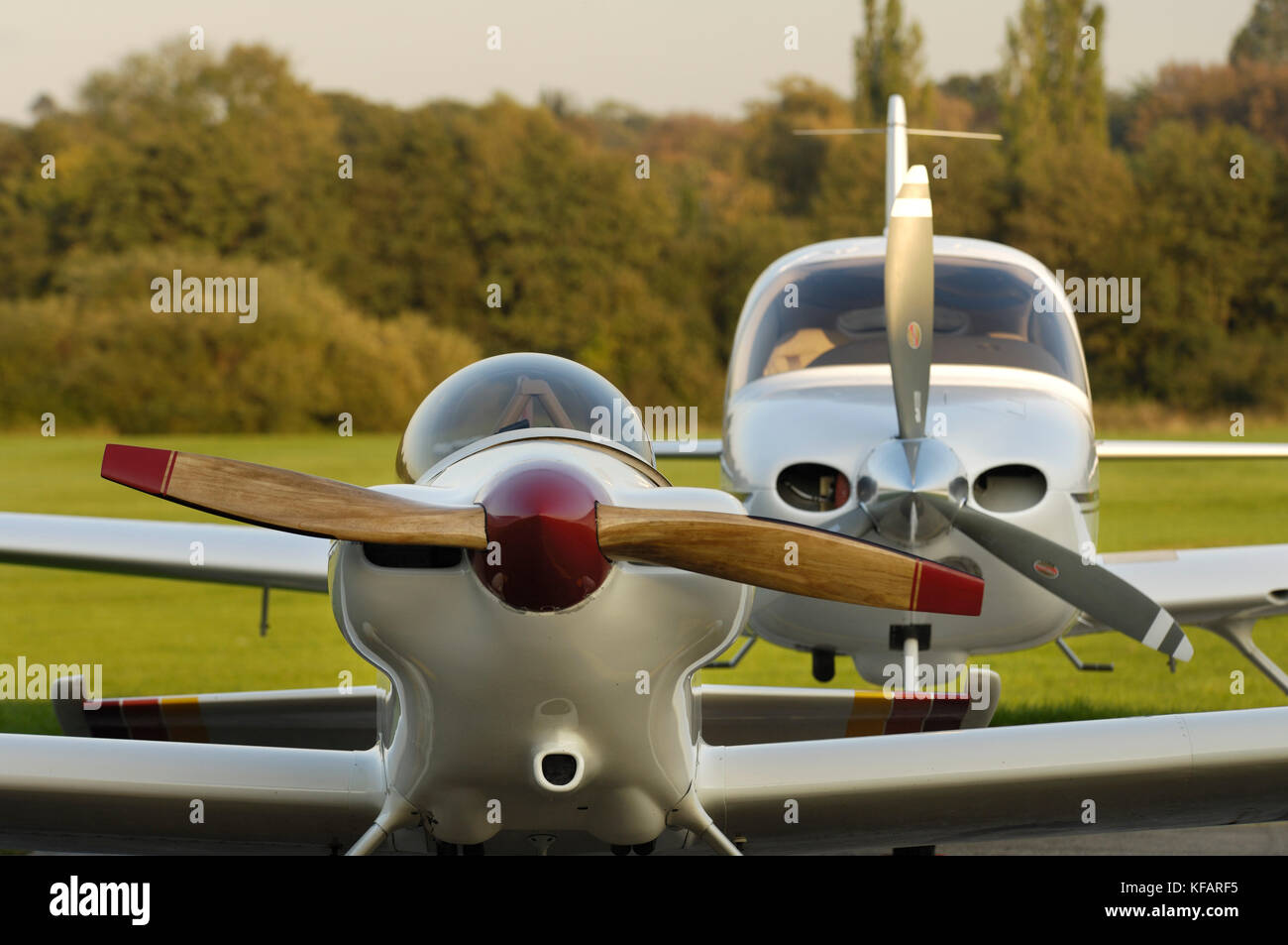 wooden propeller on a tail-wheeled light-aircraft parked with a Cirrus ...