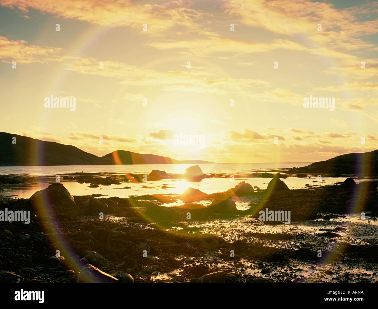 Walk within sunset on beach. Mirroring of sunsetting horizon in sea ...