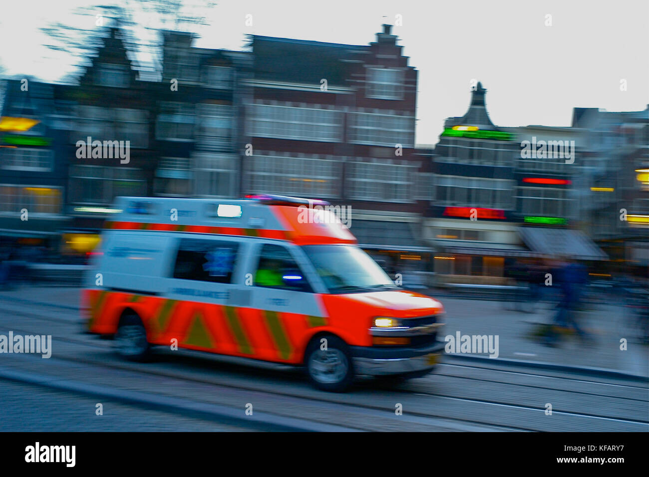 A Dutch ambulance runs through city center's street, Amsterdam ...