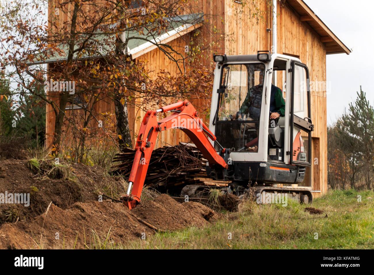 Mini excavator on construction site. Construction of a family house ...