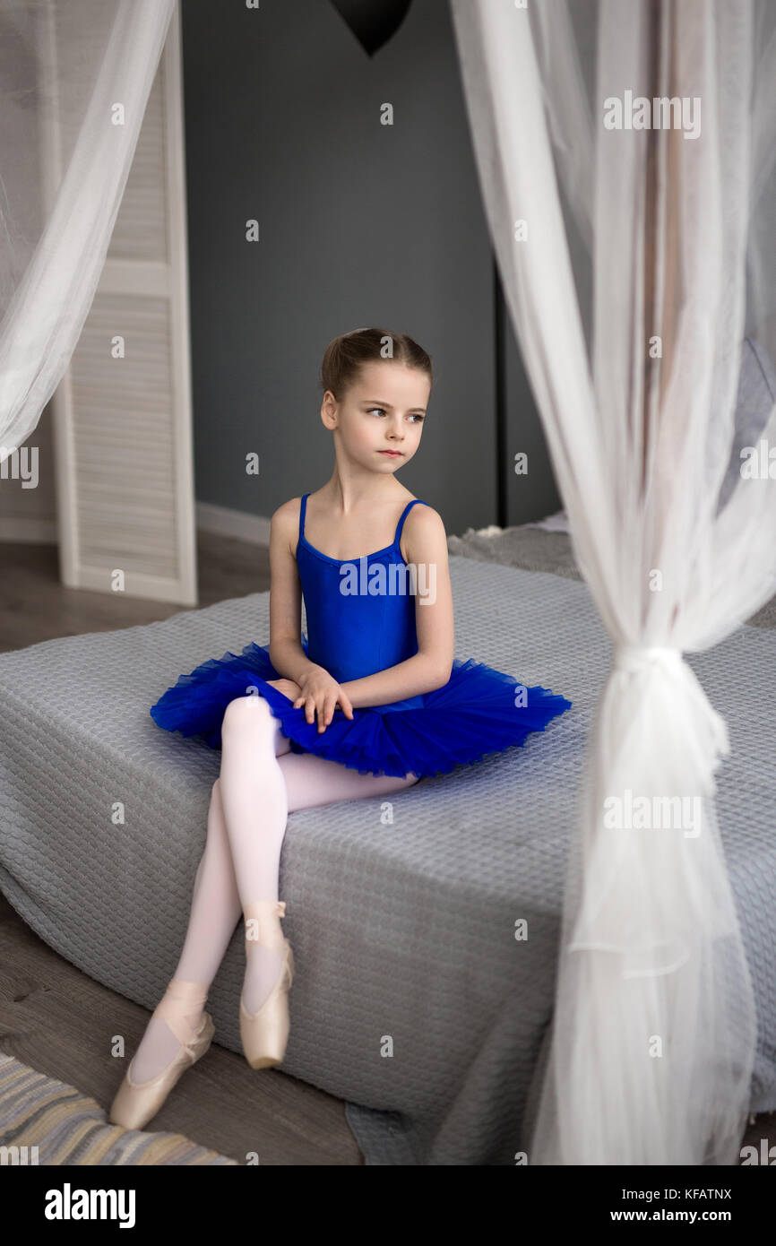 little girl dreams of becoming a ballerina. Child girl in a blue ballet ...