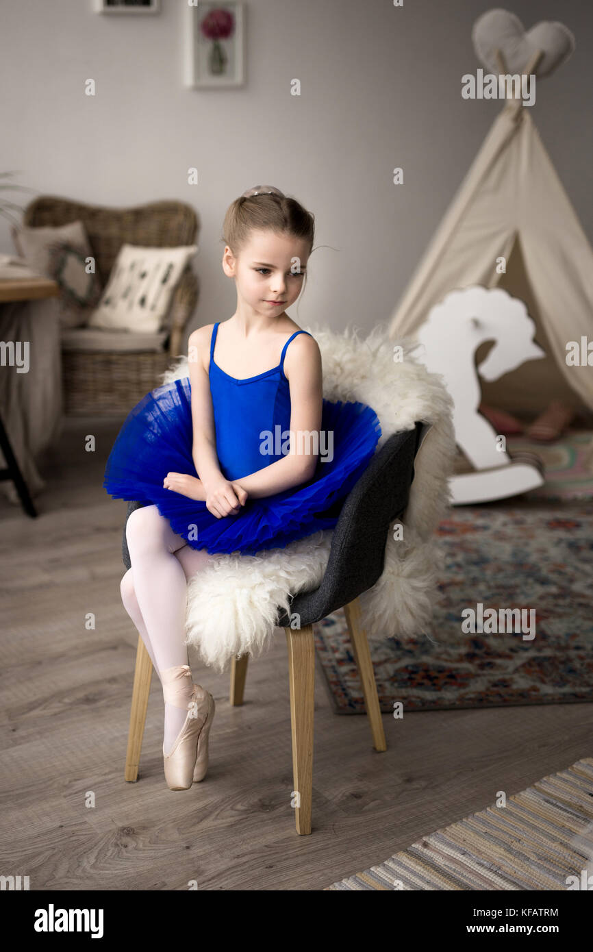 little girl dreams of becoming a ballerina. Child girl in a blue ballet ...