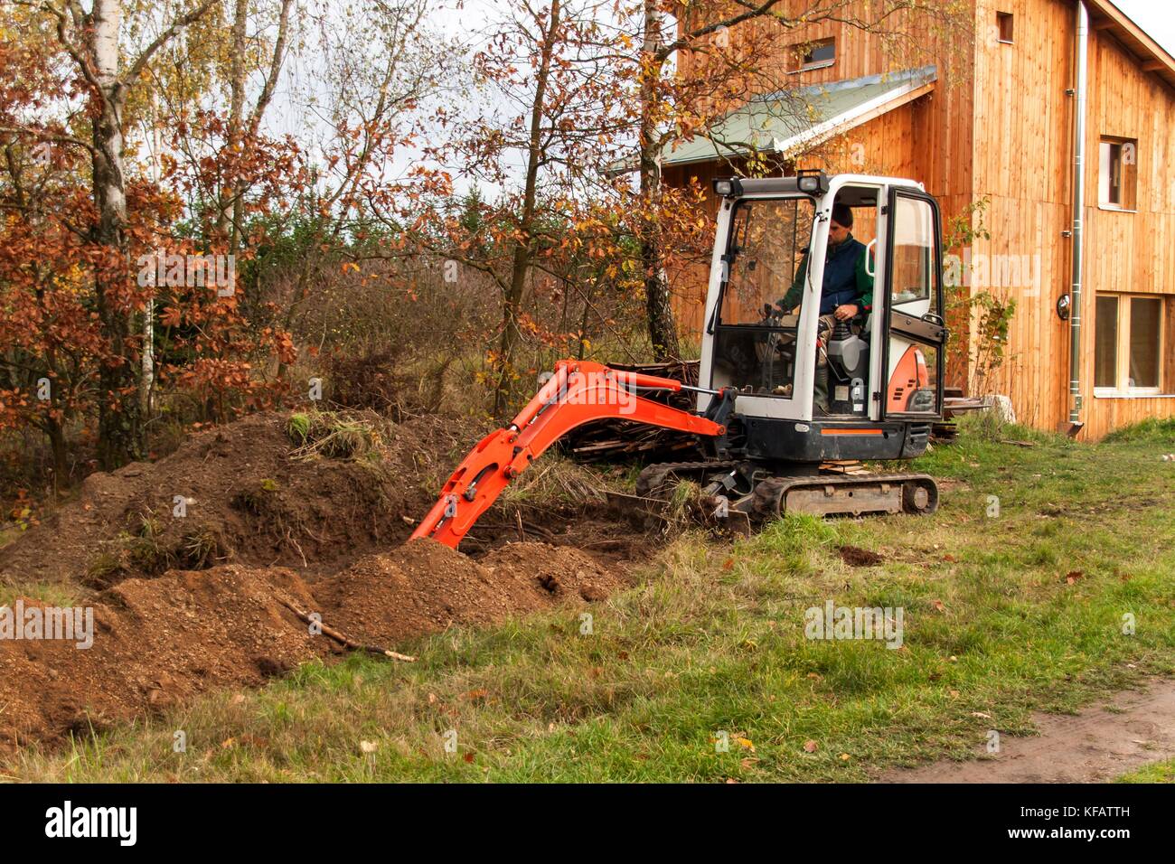 Mini excavator on construction site. Construction of a family house ...