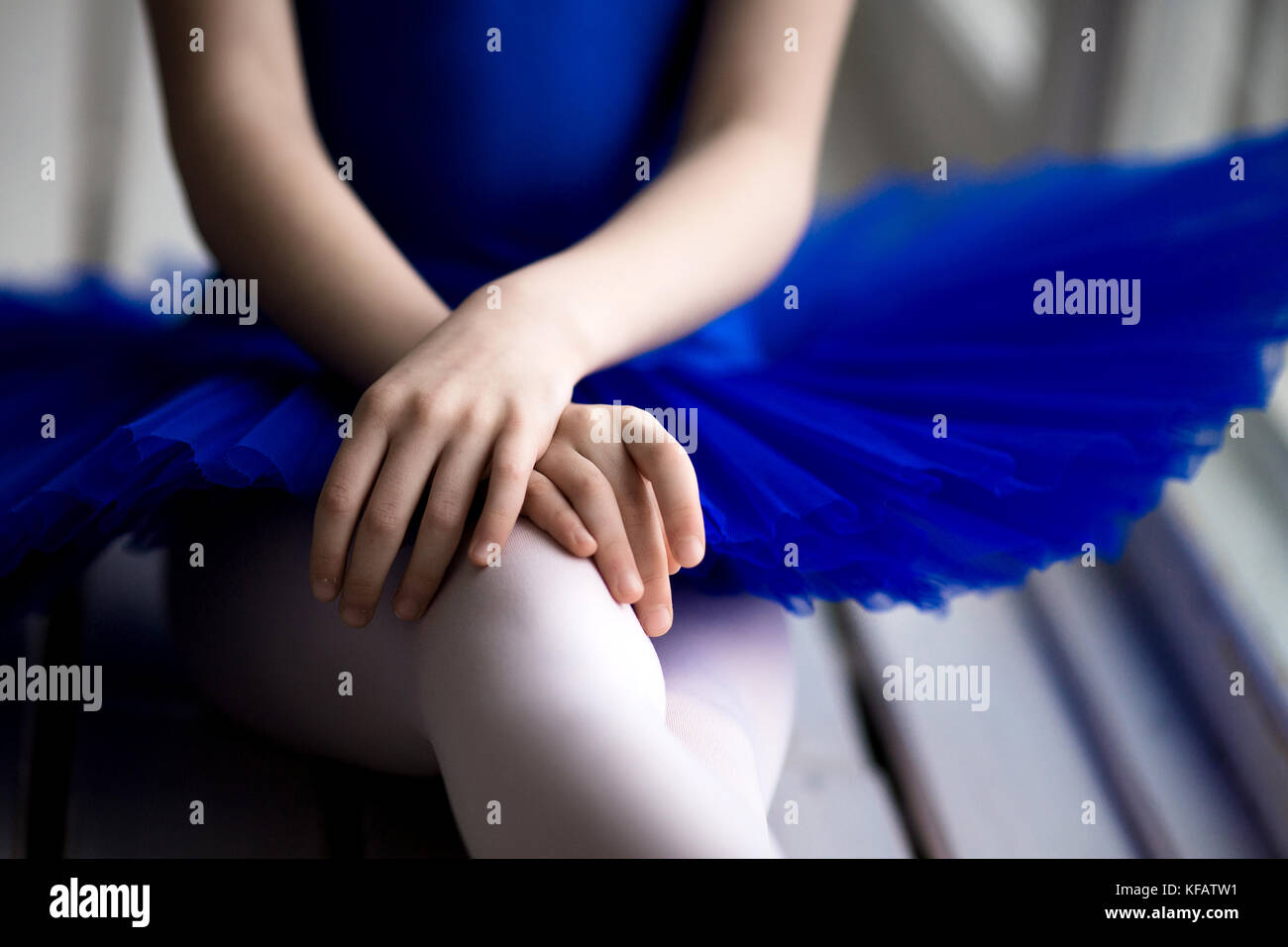 little girl dreams of becoming a ballerina. Child girl in a blue ballet ...