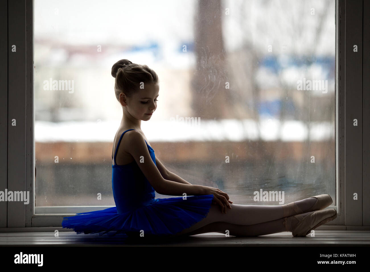 little girl dreams of becoming a ballerina. Child girl in a blue ballet ...