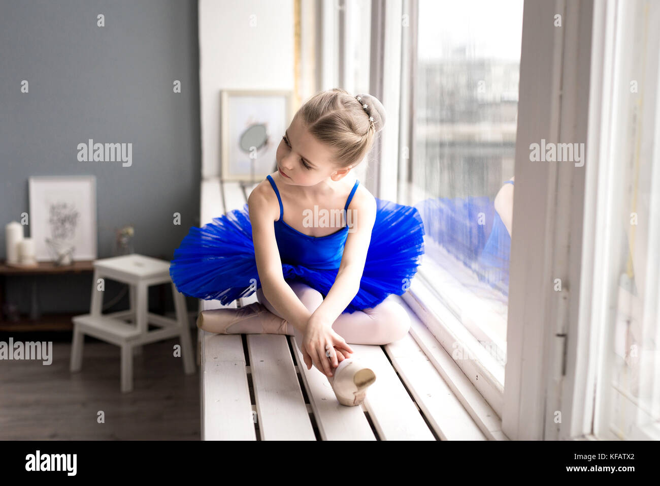 little girl dreams of becoming a ballerina. Child girl in a blue ballet ...