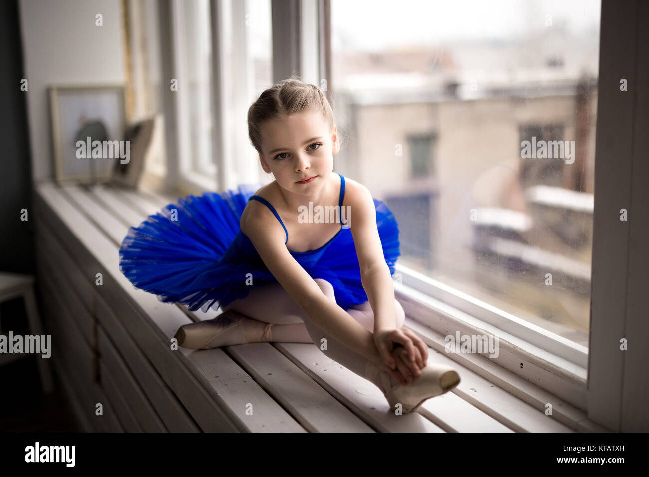 little girl dreams of becoming a ballerina. Child girl in a blue ballet ...