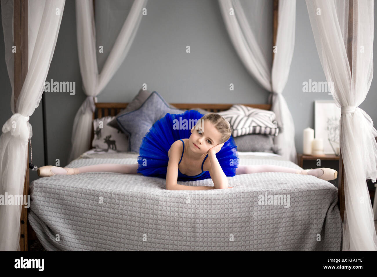 little girl dreams of becoming a ballerina. Child girl in a blue ballet ...