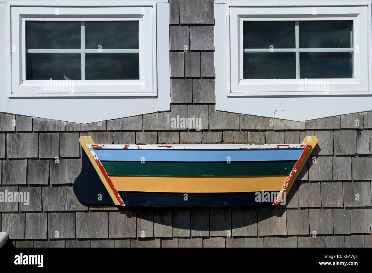 A quirky facade of a Cape Cod shack with weathered-gray shingles, two ...