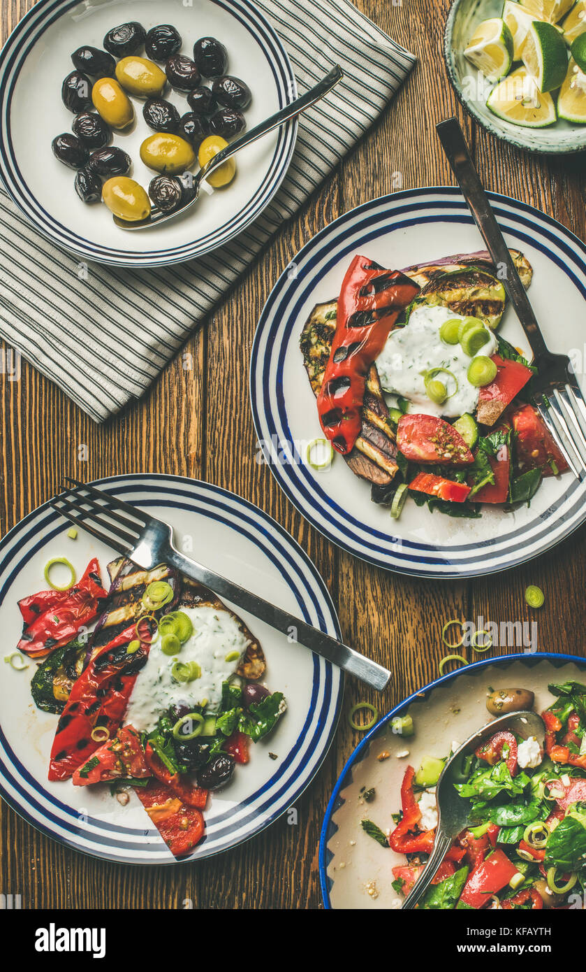 Flat-lay of healthy dinner table setting. Green salad, grilled ...