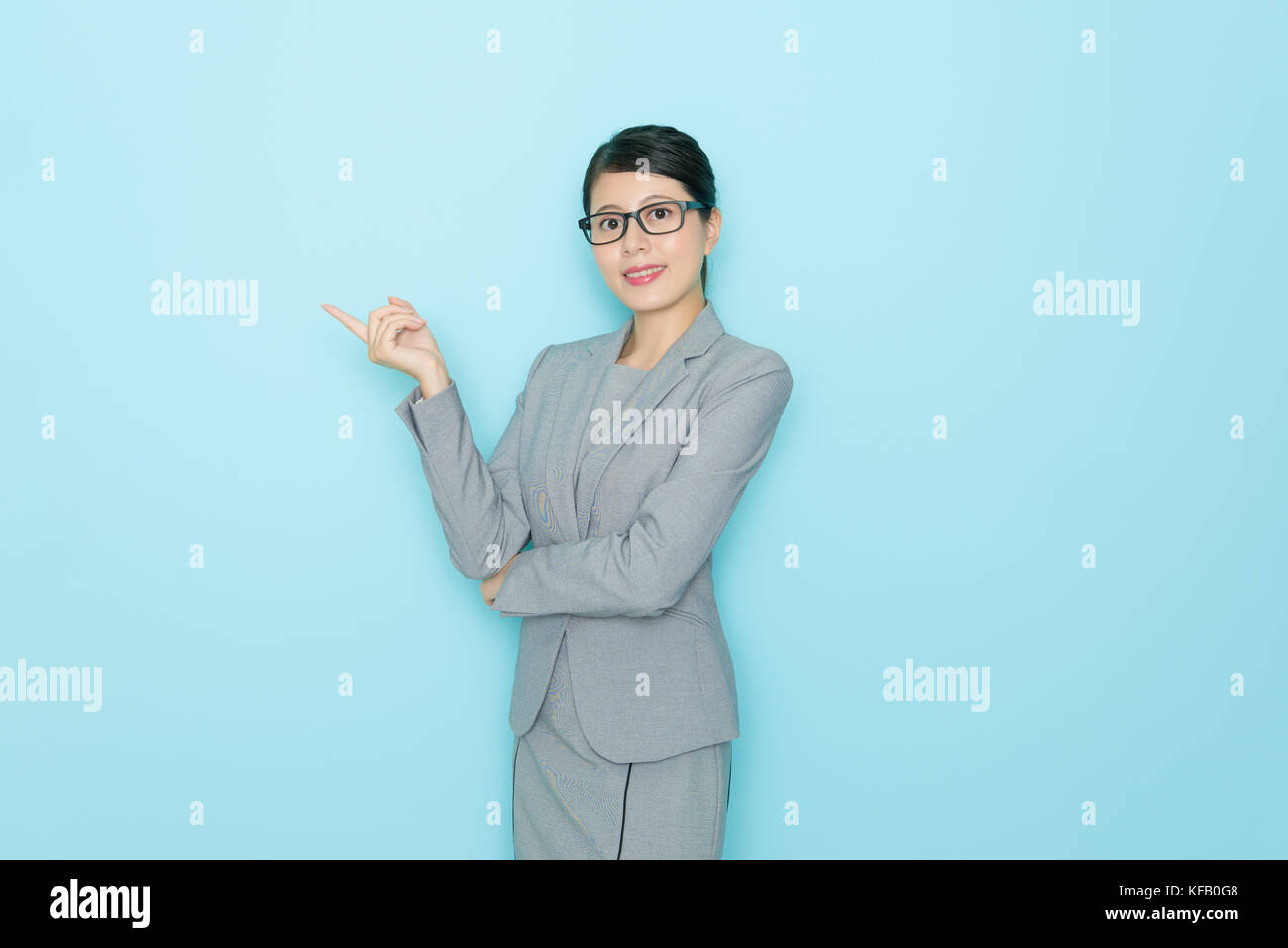 happy confident woman right banker standing in blue wall background ...