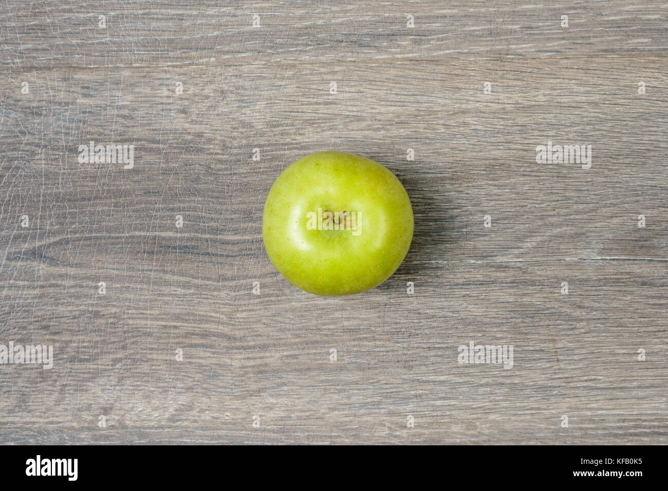 Apple on wooden table Stock Photo - Alamy