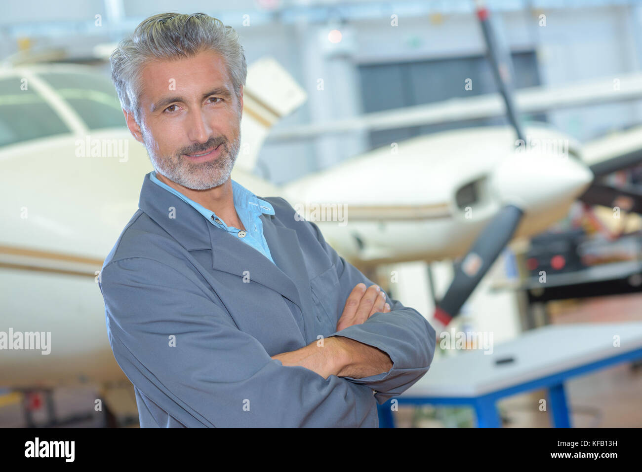 Portrait of worker by aircraft Stock Photo - Alamy