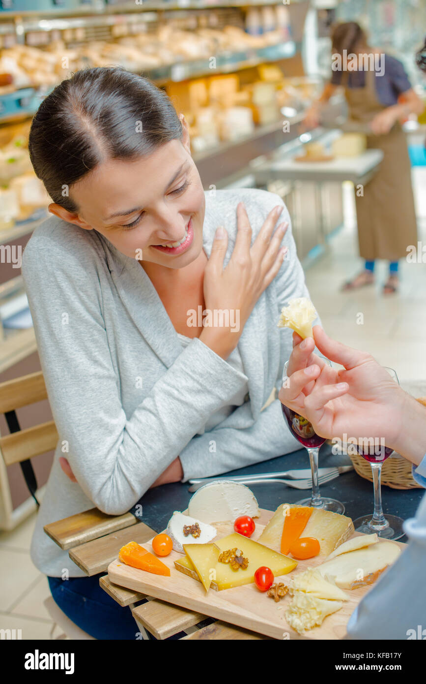 Lady having meal, being offered cheese Stock Photo - Alamy