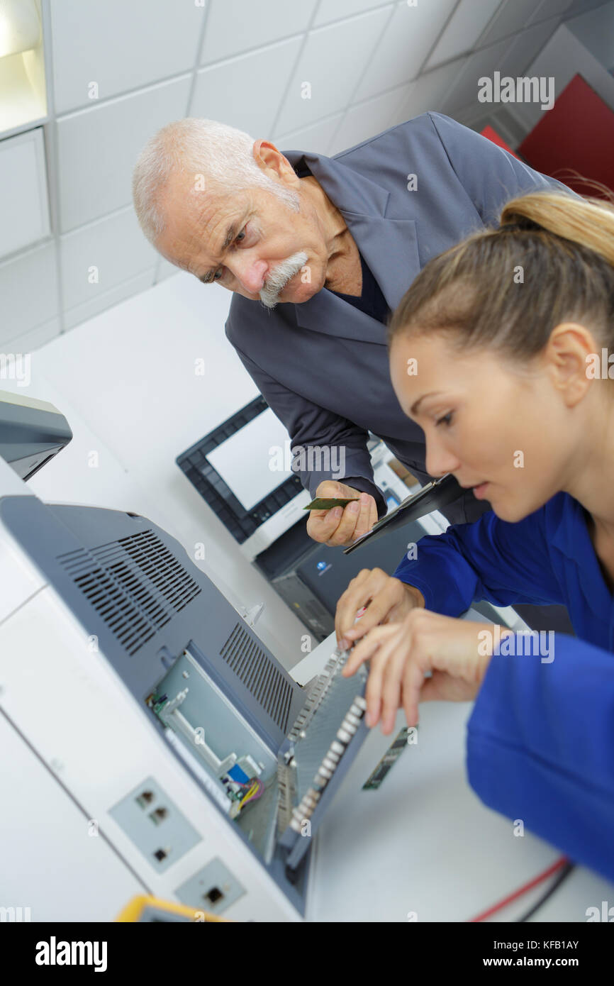 computer it support worker fixing machine in office Stock Photo - Alamy