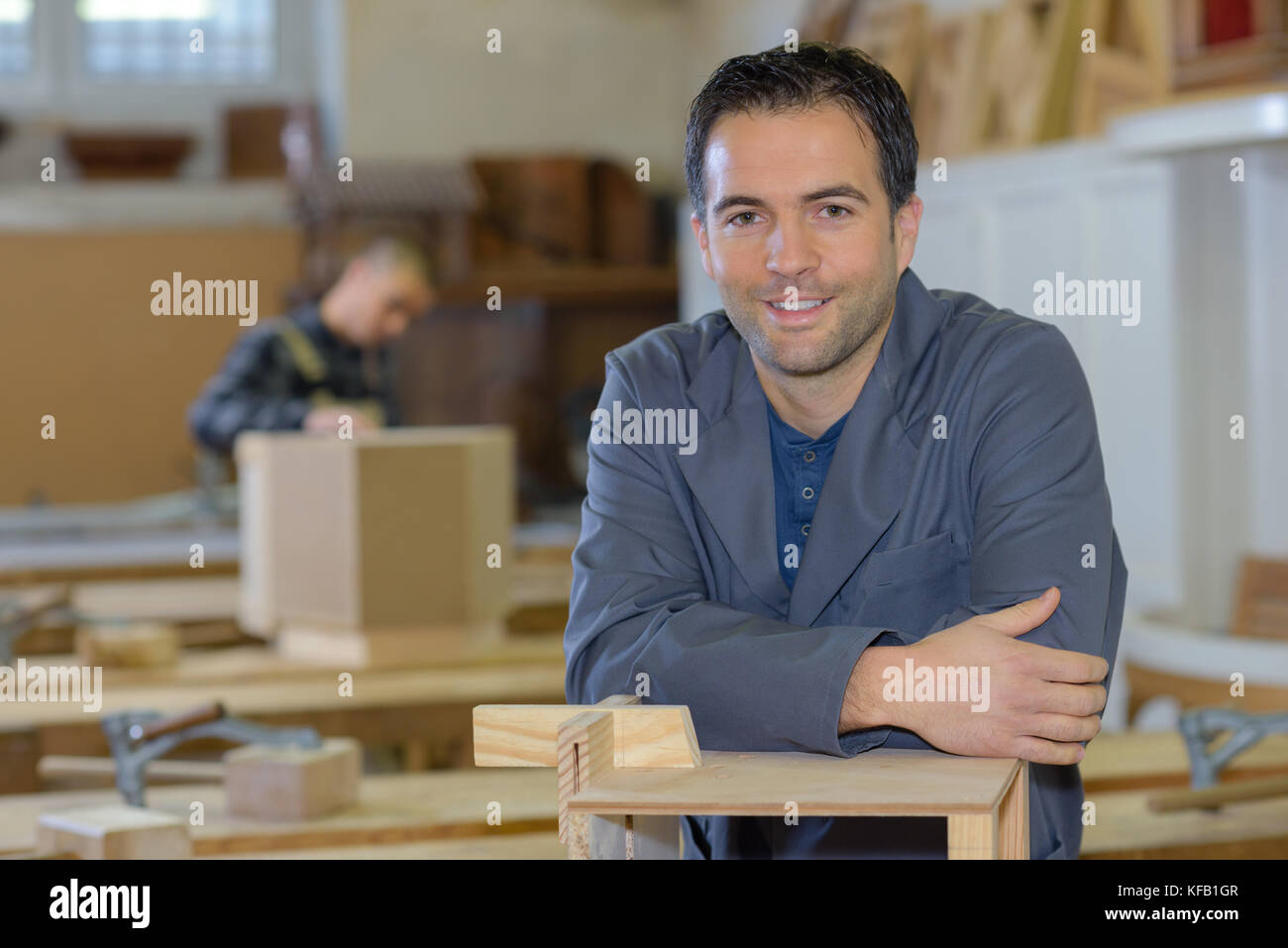 middle aged male carpenter standing behind working table Stock Photo ...