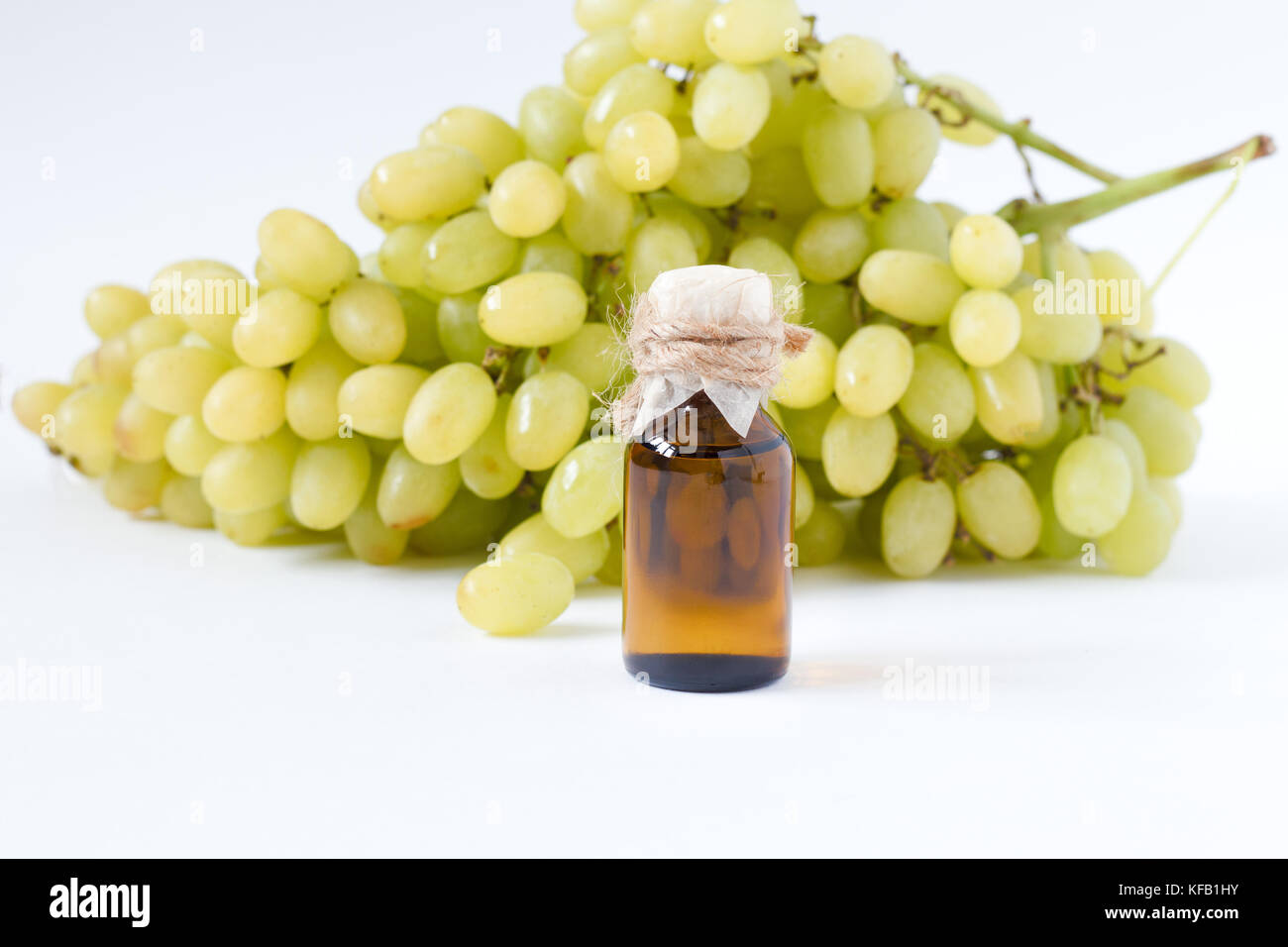 Bottle with grape seed essential oil on a white background Stock Photo ...