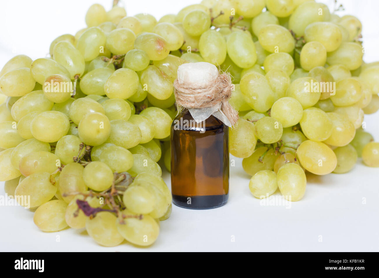 Bottle with grape seed essential oil on a white background Stock Photo ...