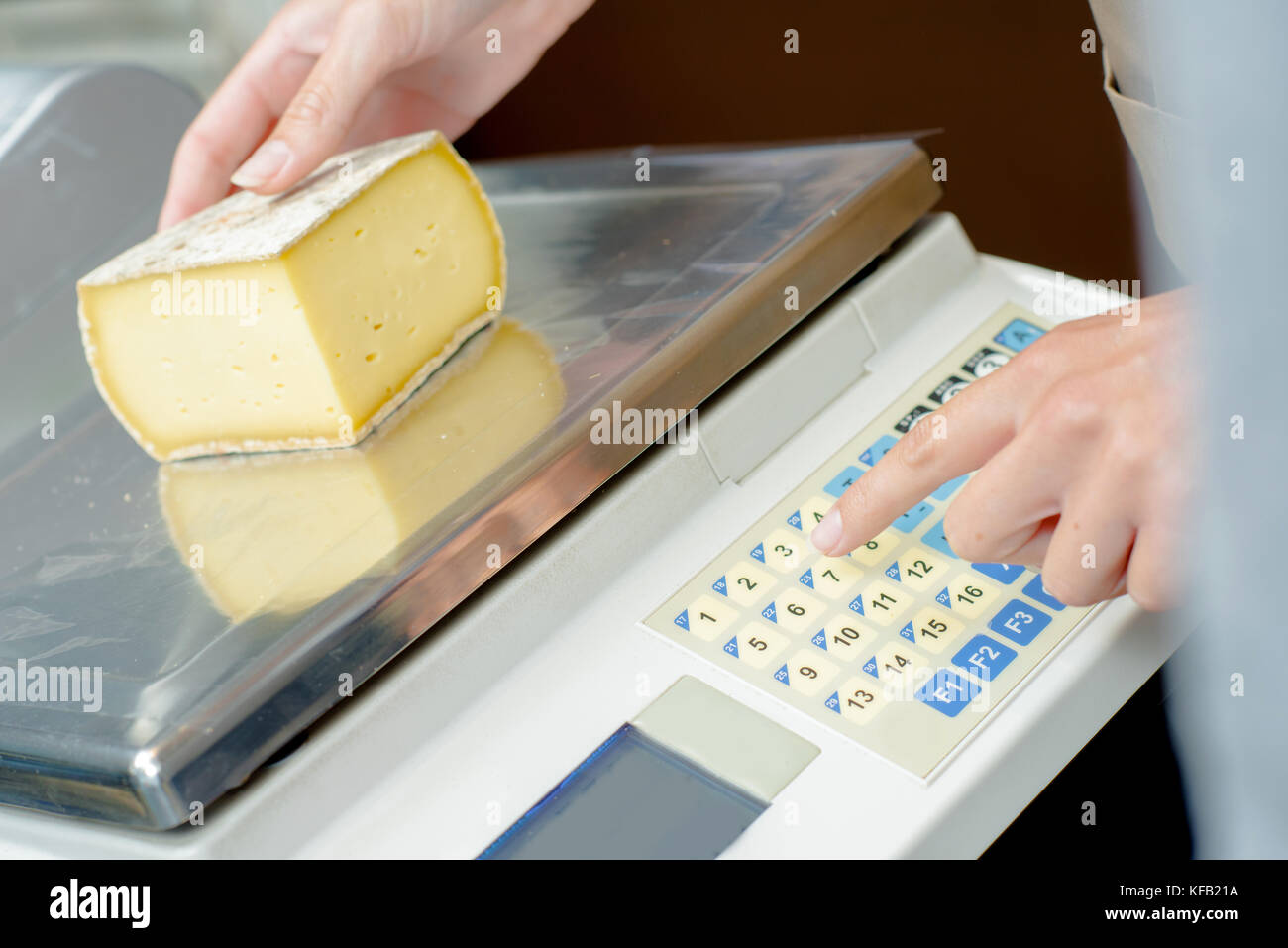 Weighing chunk of cheese on scales Stock Photo - Alamy