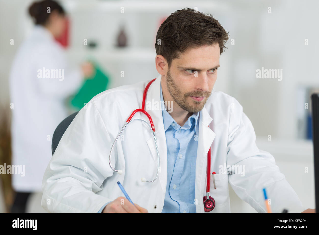 handsome young doctor at work in his office Stock Photo - Alamy