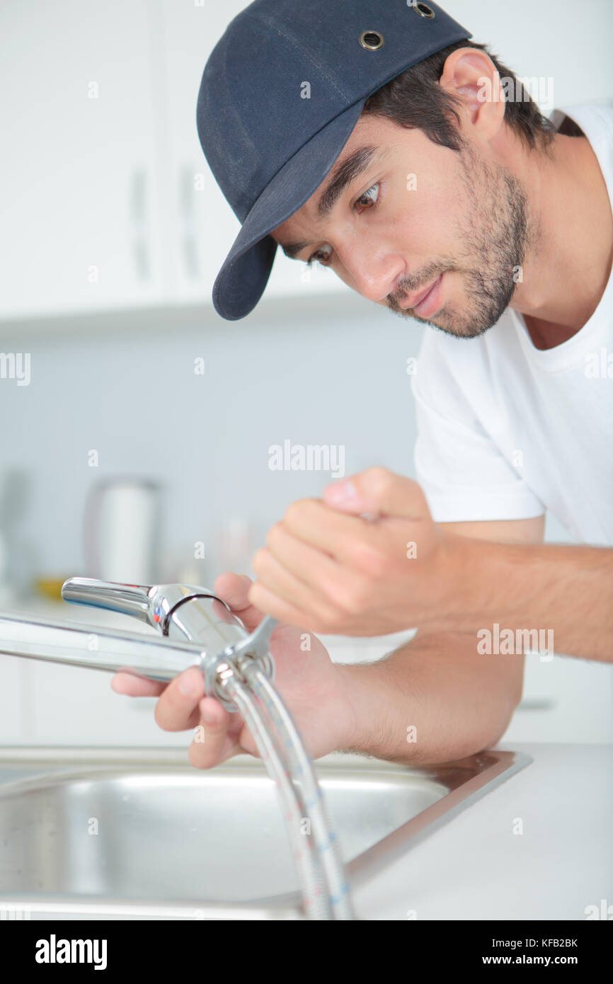 fixing a loose tap Stock Photo - Alamy