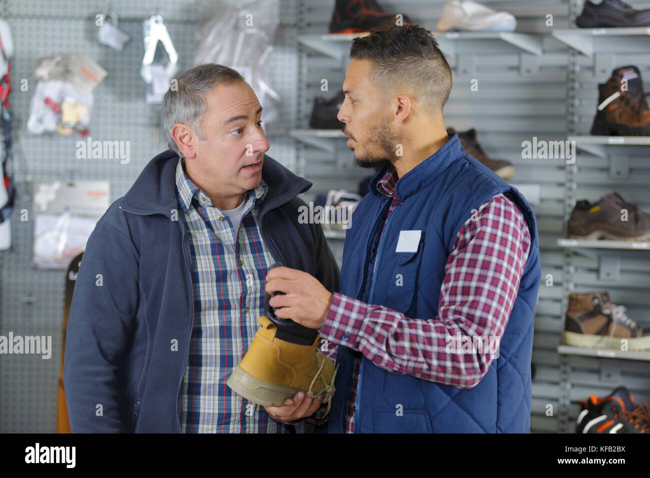 2 workers buying working shoes at store Stock Photo - Alamy