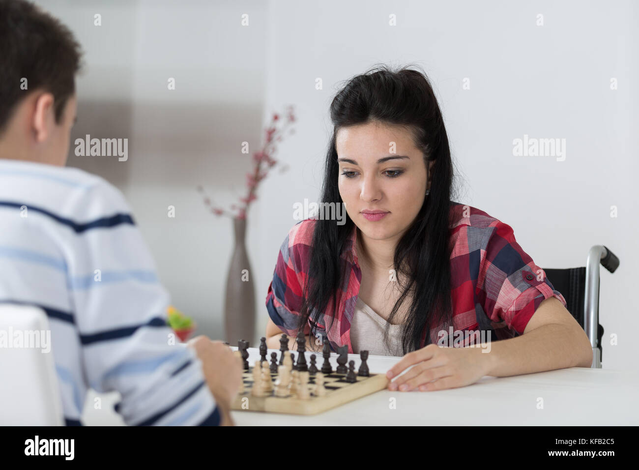 young couple playing chess indoo Stock Photo - Alamy