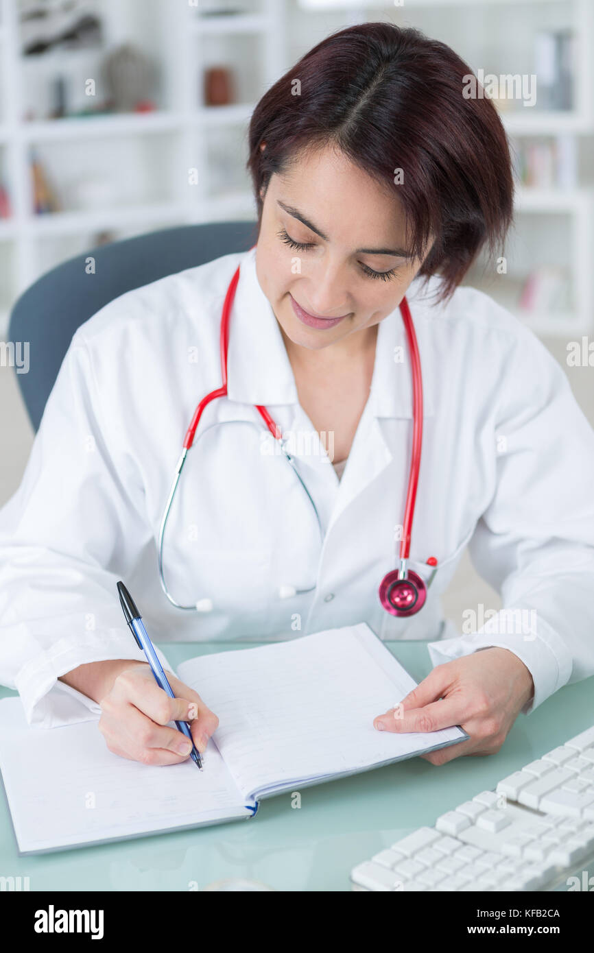 writing prescription after diagnosing sick patient Stock Photo - Alamy