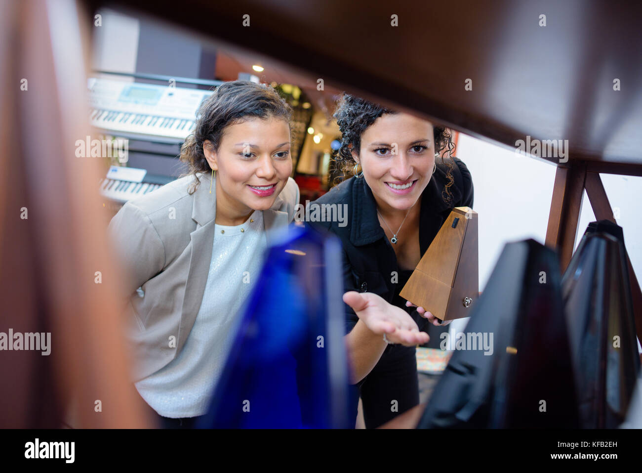 young female customer with assistant in a boutique Stock Photo - Alamy