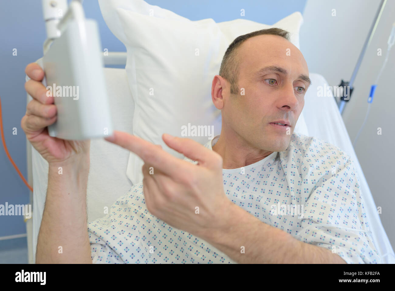 patient on bed pointing at machine Stock Photo - Alamy