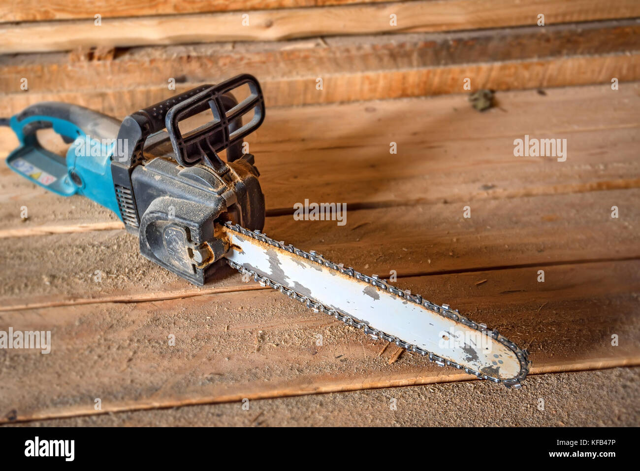 Chainsaw on lumber background Stock Photo - Alamy