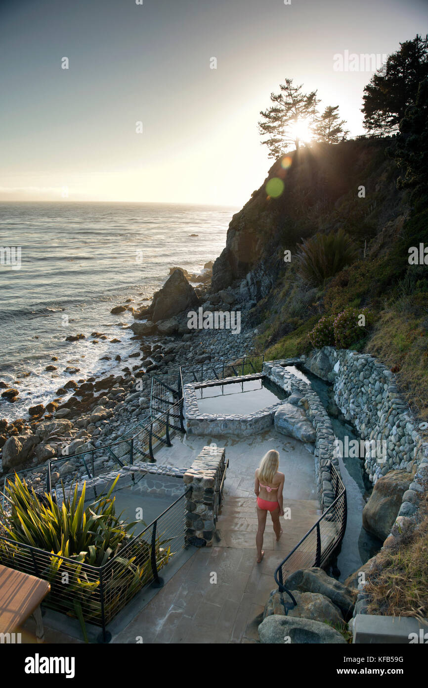 USA, California, Big Sur, Esalen, woman walks down to the Baths to take ...