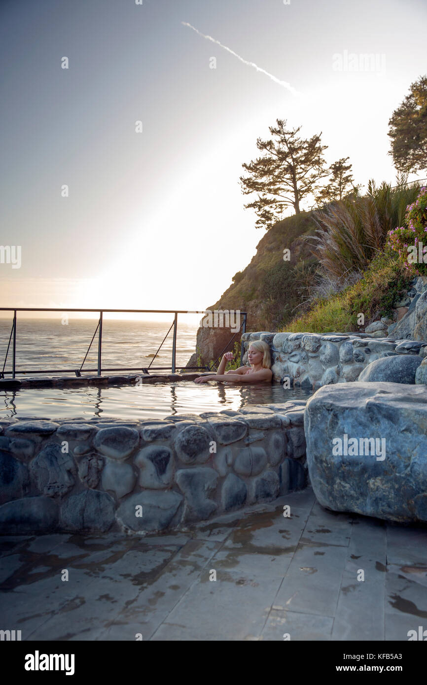 USA, California, Big Sur, Esalen, a woman sits in the Baths and takes ...