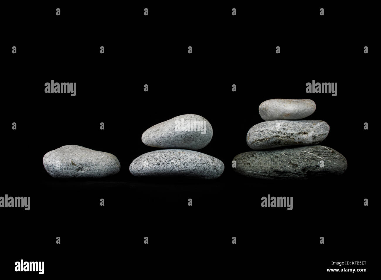 Concept of gowth. Stones on black background Stock Photo - Alamy