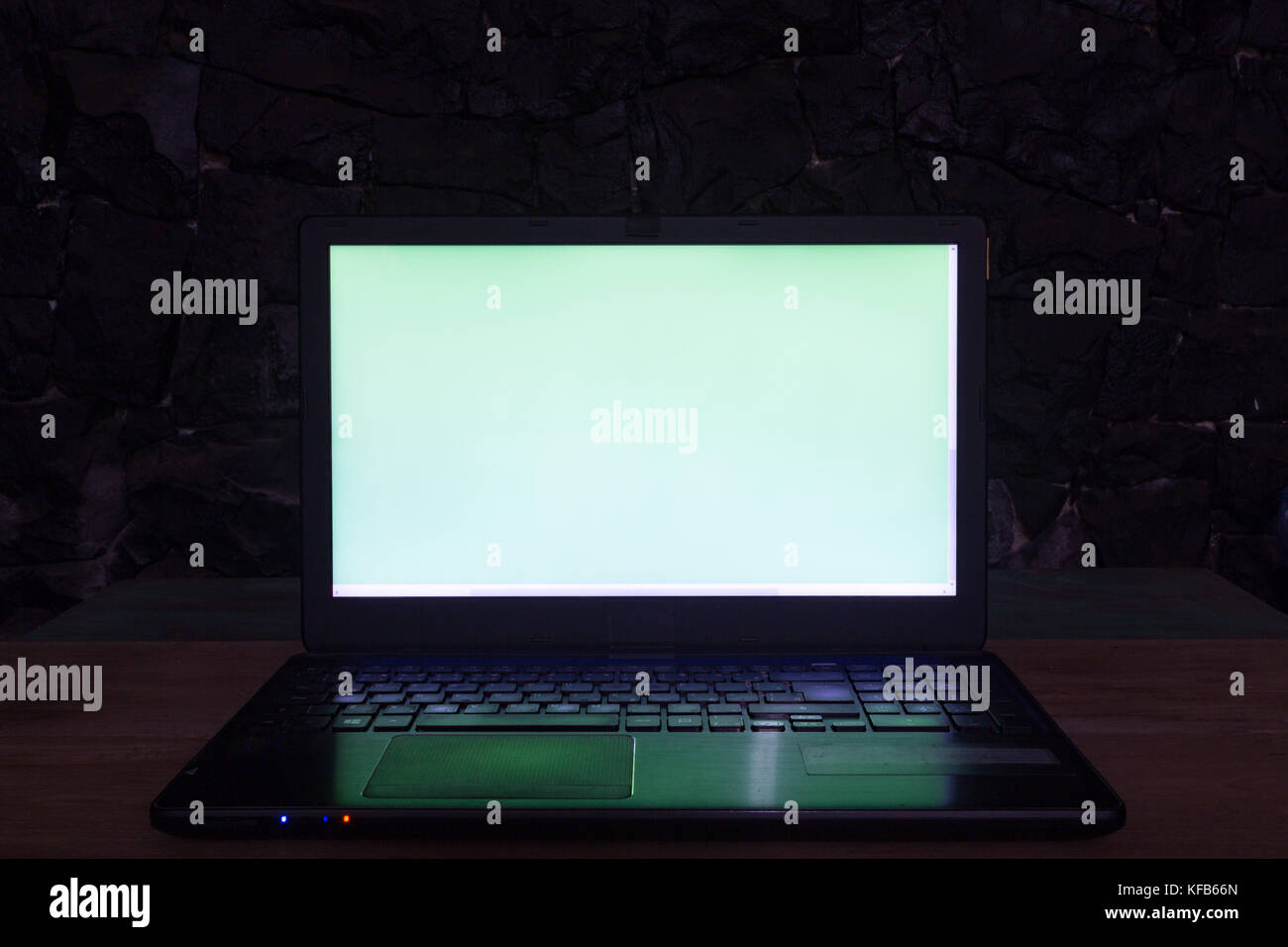 Laptop computer screen illuminated, empty room Stock Photo - Alamy