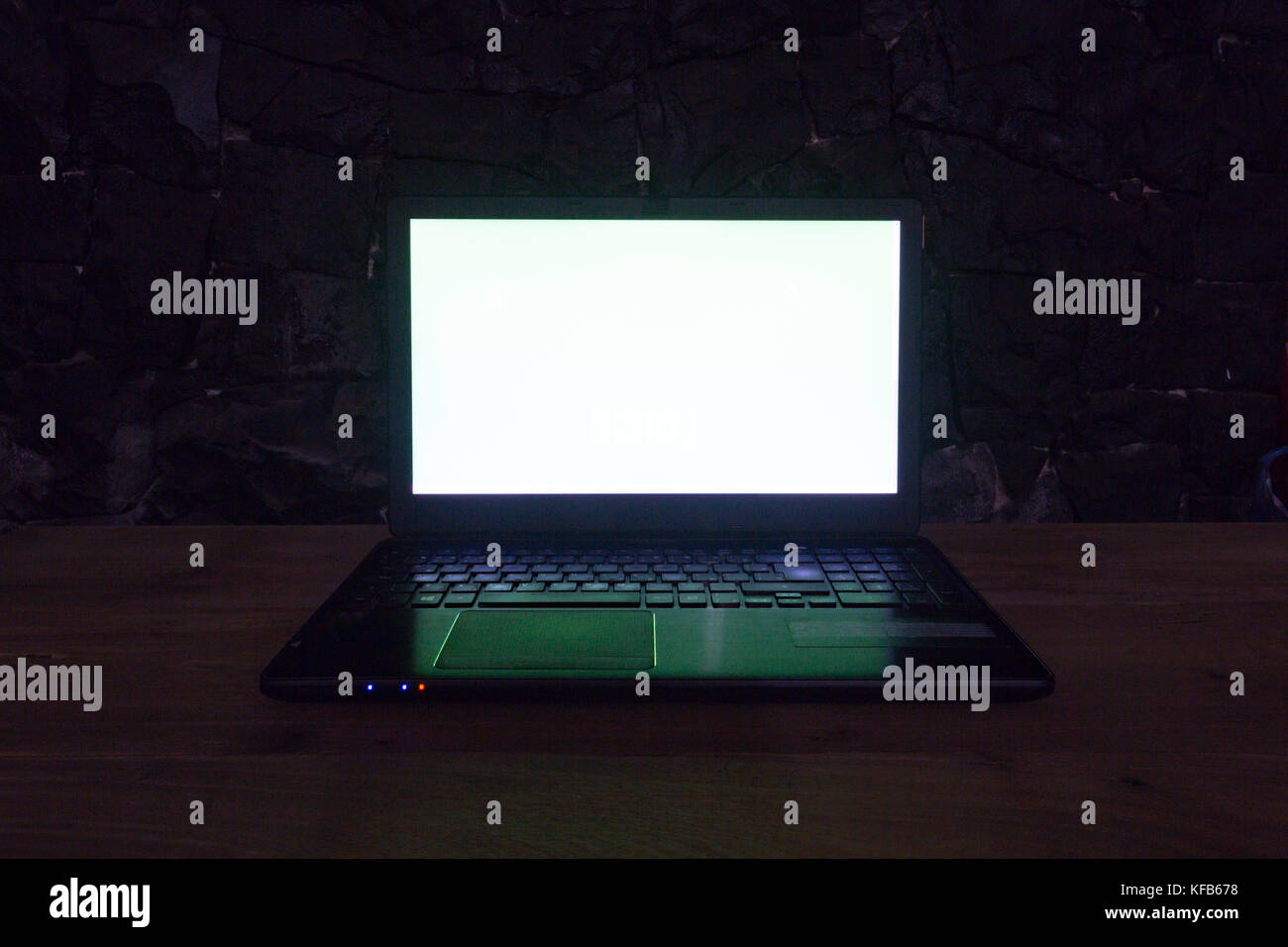 Laptop computer screen illuminated, empty room Stock Photo - Alamy