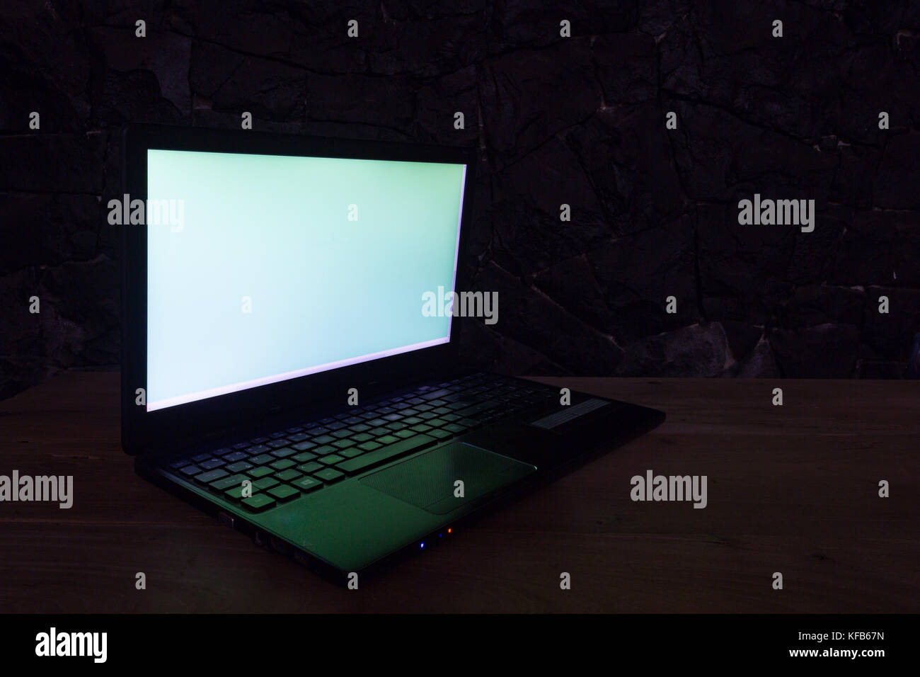 Laptop computer screen illuminated, empty room Stock Photo - Alamy
