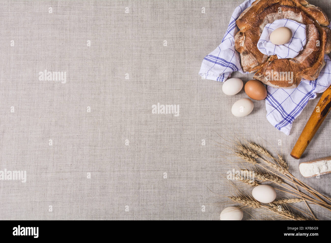 Homemade Ukrainian bread Kalach, eggs, flour, rolling pin and ears of ...