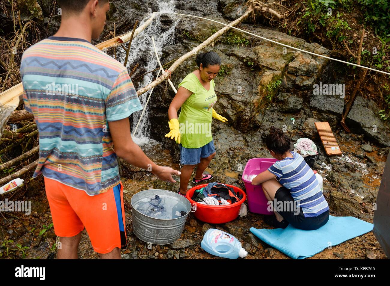 Puerto Rican residents wash their clothes in runoff mountain water in ...