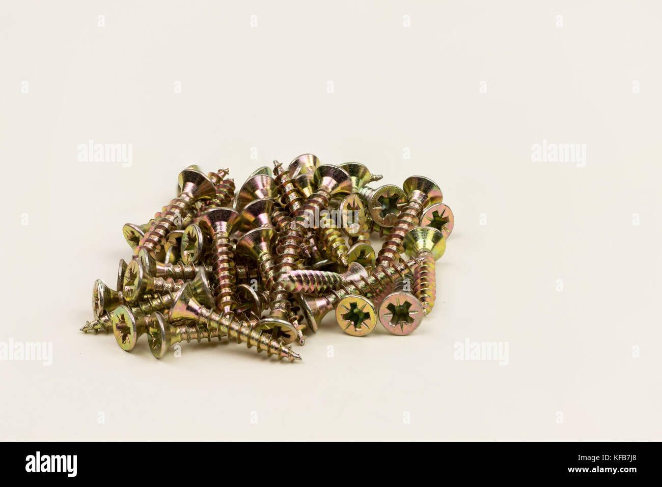 Pile of small gold plated Counter Sunk wood screws Stock Photo - Alamy