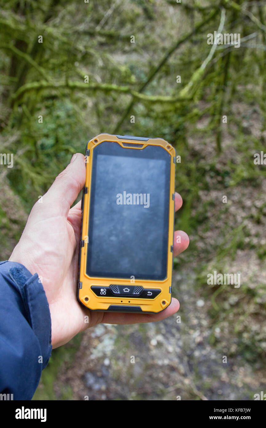 smartphone tracking travel on mountain trails. Phone in hand in a ...