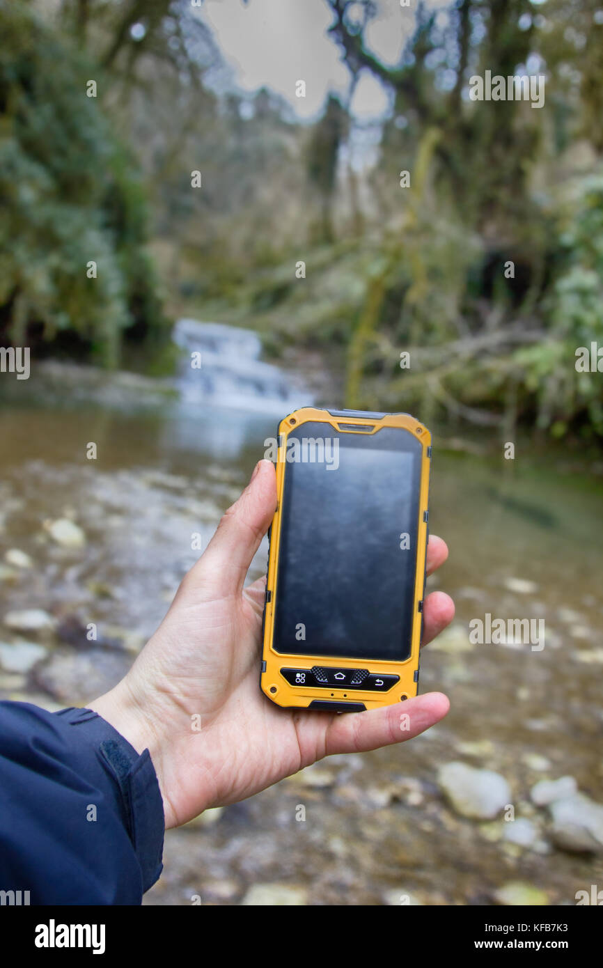 smartphone tracking travel on mountain trails. Phone in hand in a ...