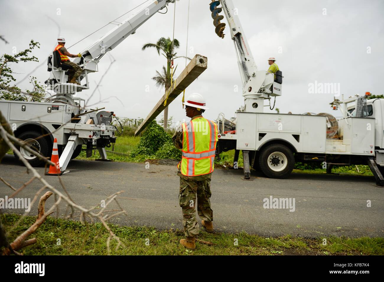 U.S. Army soldiers and Prime Power employees repair power lines during ...