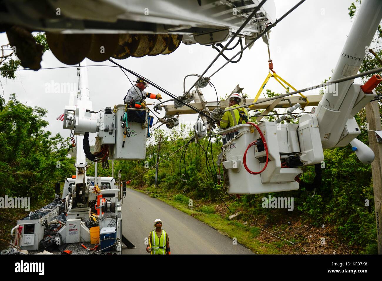 U.S. Army soldiers and Prime Power employees repair power lines during ...